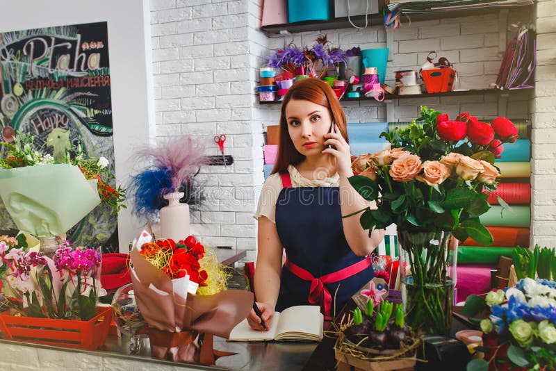 Young Girl Working in a Flower Shop, Florist Woman Makes a Bouquet ...