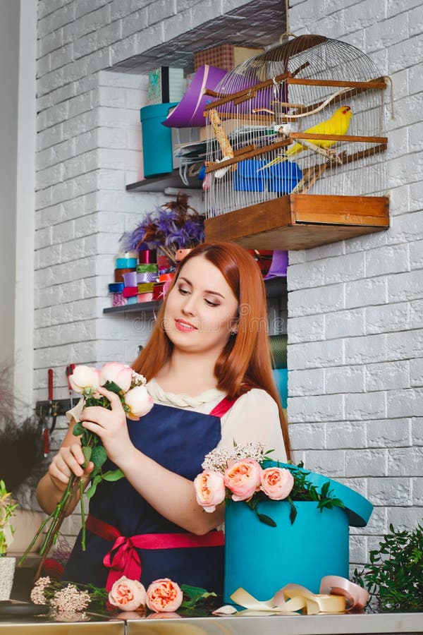 Young Girl Working in a Flower Shop, Florist Woman Makes a Bouquet ...