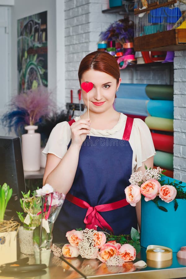 Young Girl Working in a Flower Shop, Florist Woman Makes a Bouquet ...