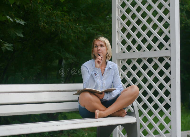Young Girl Writing in Her Notebook at Park on Bench Stock Image - Image ...