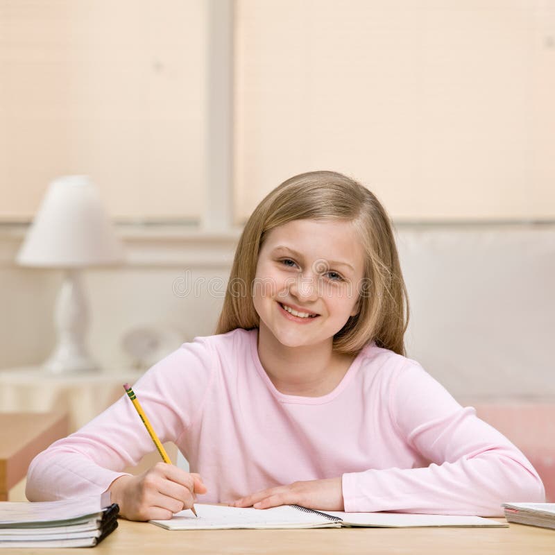 Young Girl Writing Homework in Notebook Stock Image - Image of ...