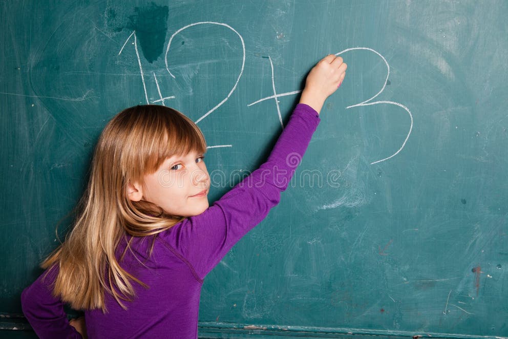 Young Girl Writing Numbers on Chalkboard Stock Photo - Image of ...