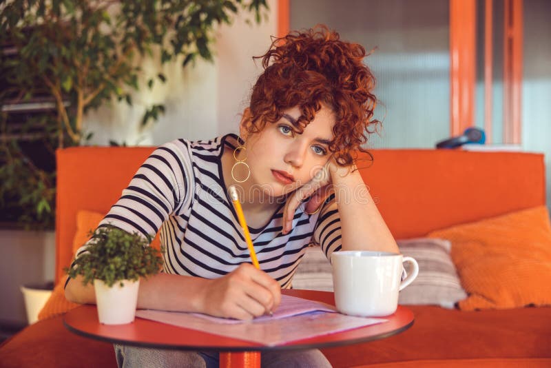 Young Girl Writing Something and Looking Tired and Bored Stock Photo ...