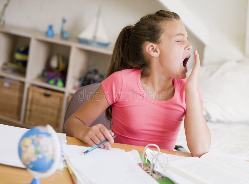 Young Girl Yawning, Doing Her Homework Stock Image - Image of ...