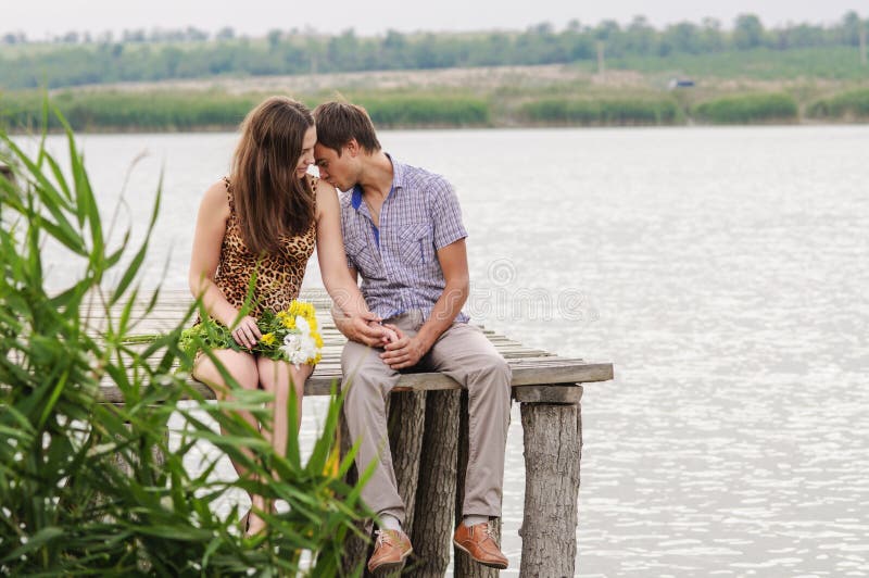 Young Girl and the Young Man on the Dock by the River Stock Image ...
