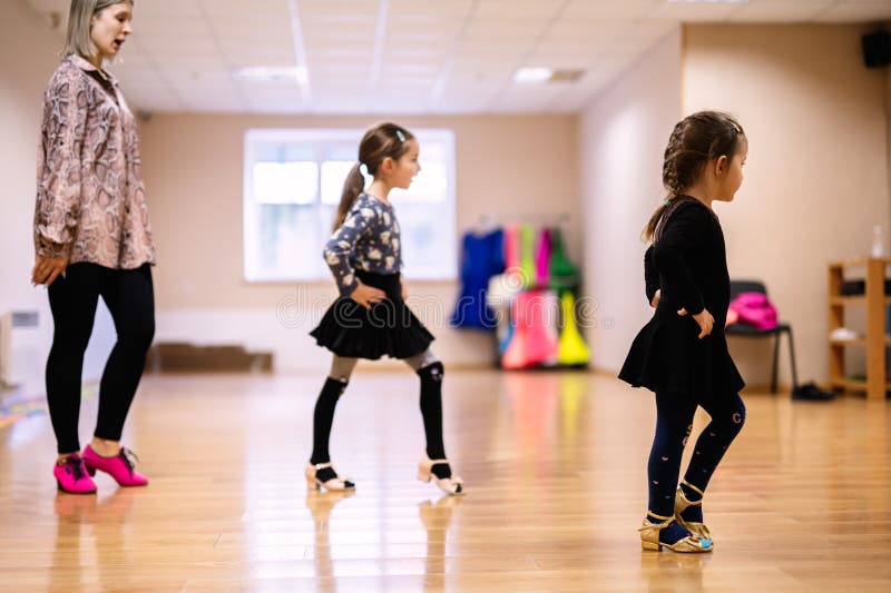 Young Girls Learning Dance Moves in Classroom with Instructor Stock ...