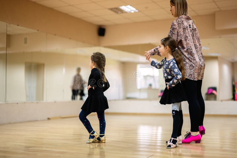 Young Girls Learning Dance in Studio with Instructor, Practicing Ballet ...