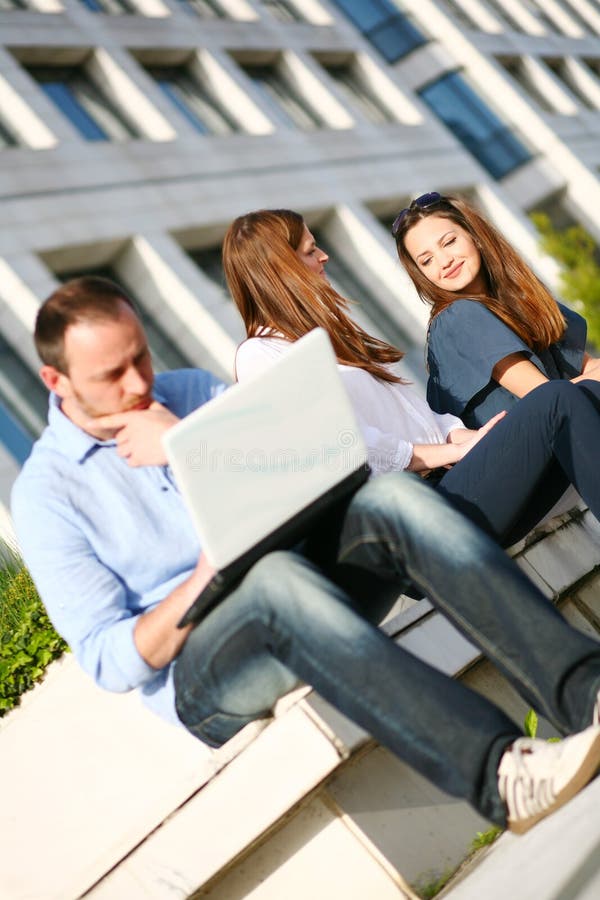 Young Girls Outdoors and Man with Laptop Stock Photo - Image of city ...