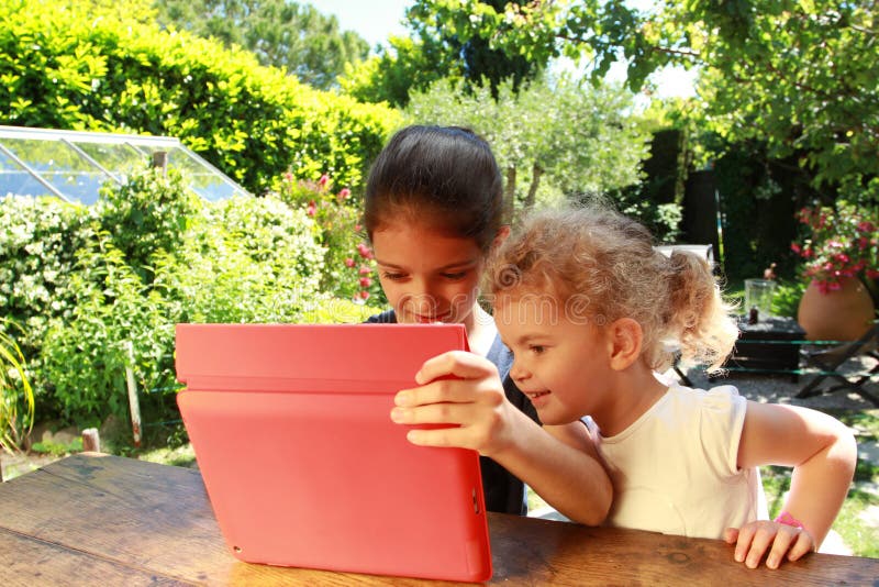 Young Girls and a PC Tablet Stock Photo - Image of sunny, children ...