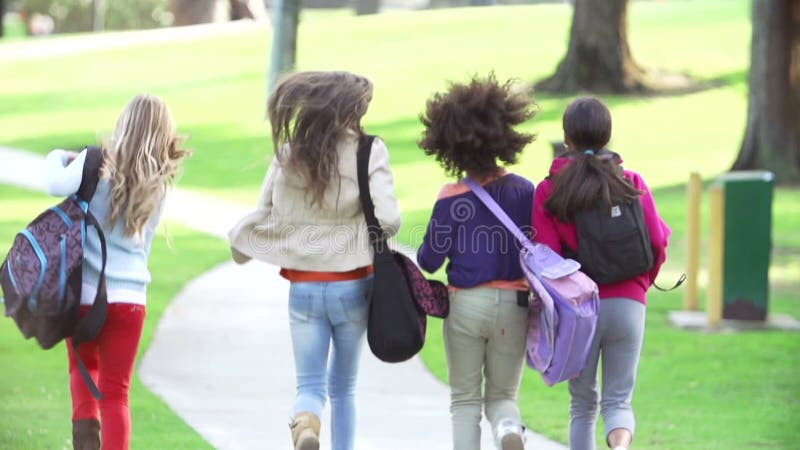 Young Girls Running in Slow Motion Away from Camera in Park Stock ...