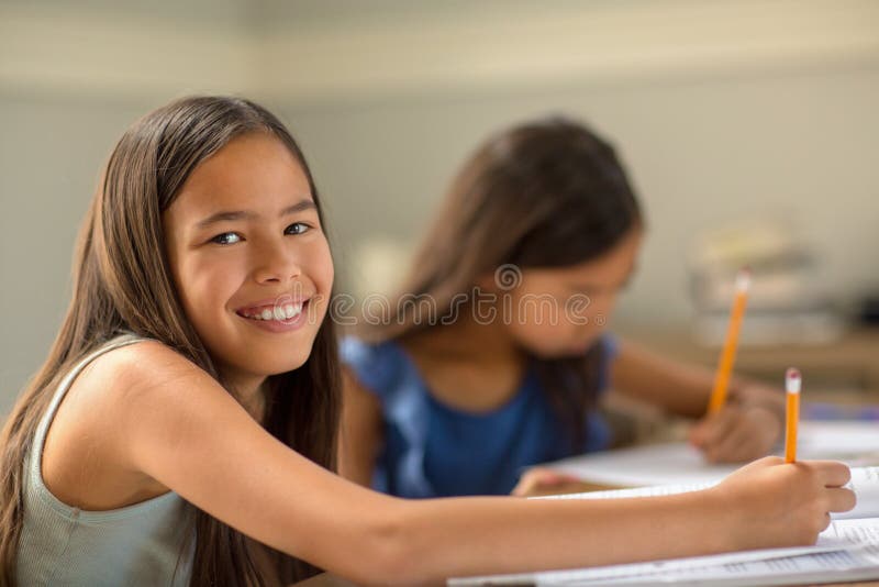 Young Girls Working on Their School Work Stock Photo - Image of writing ...