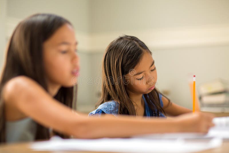 Young Girls Working on Their School Work Stock Photo - Image of ...