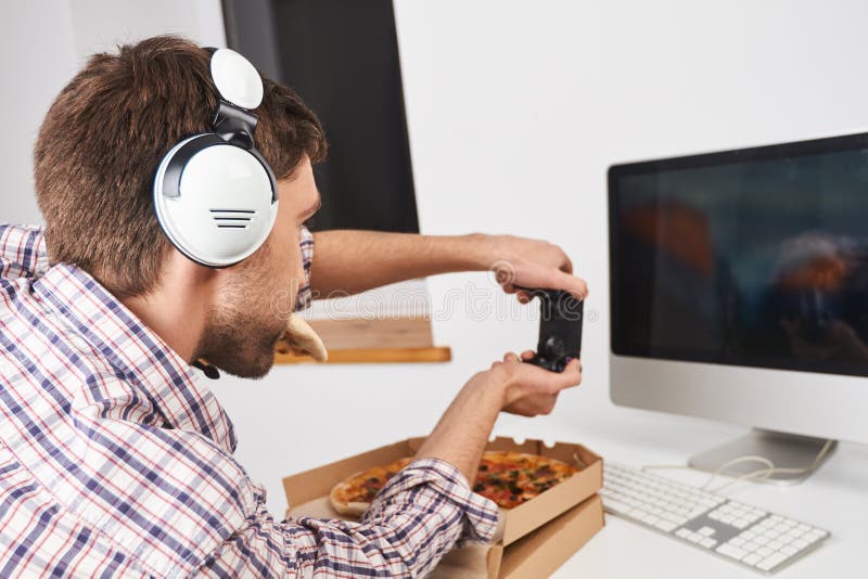 Young Good-looking Bearded Man Spending Evening after Work Playing ...