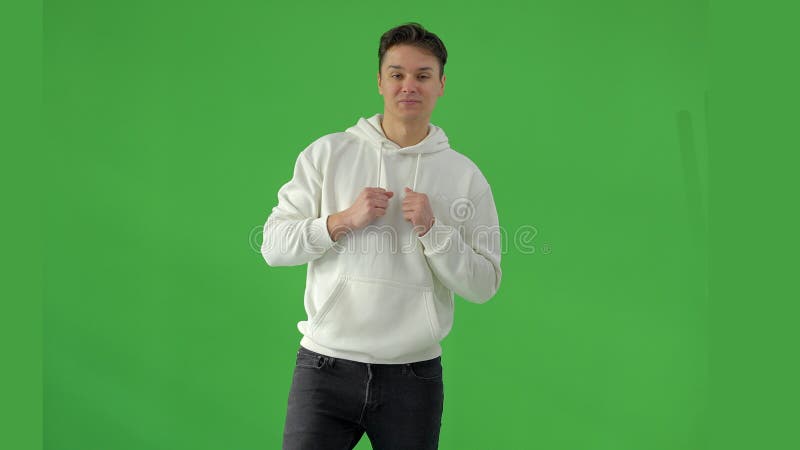 Handsome Young Man Smiles at the Camera in a Green Screen Studio Stock ...