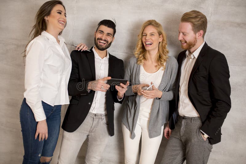 Young Good Looking People Standing Together Over Wall Background Stock ...