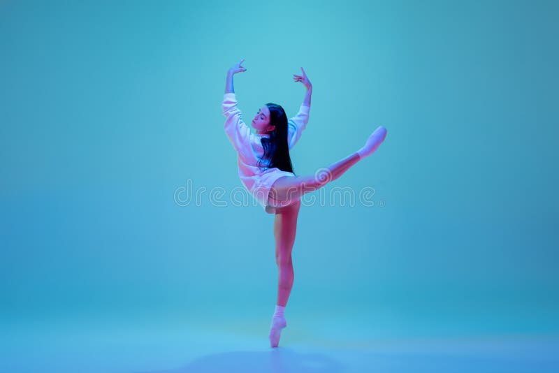 Young and Graceful Ballet Dancer Isolated on Blue Studio Background in ...
