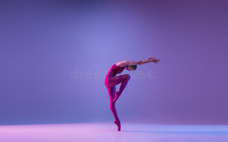 Young and Graceful Ballet Dancer Isolated on Purple Studio Background ...