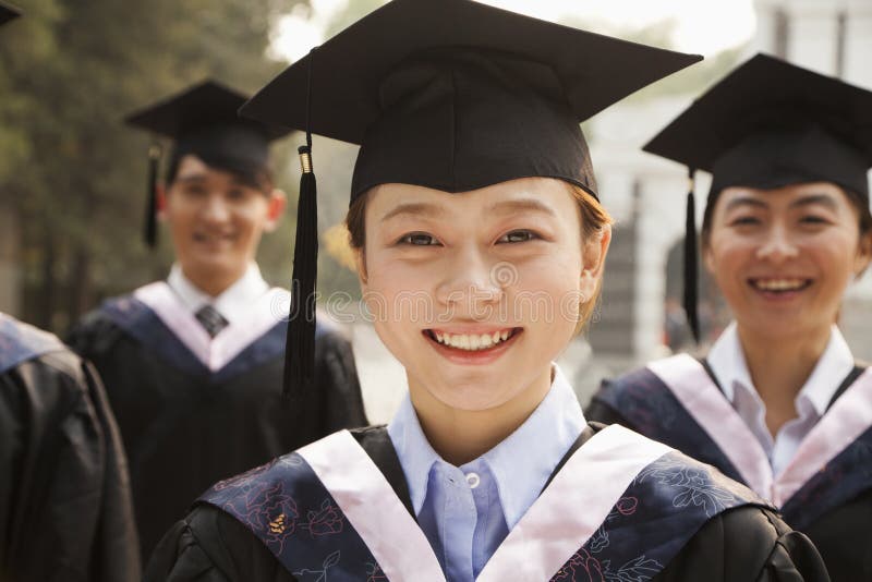 Young Graduates Walking Across Campus Stock Photo - Image of education ...