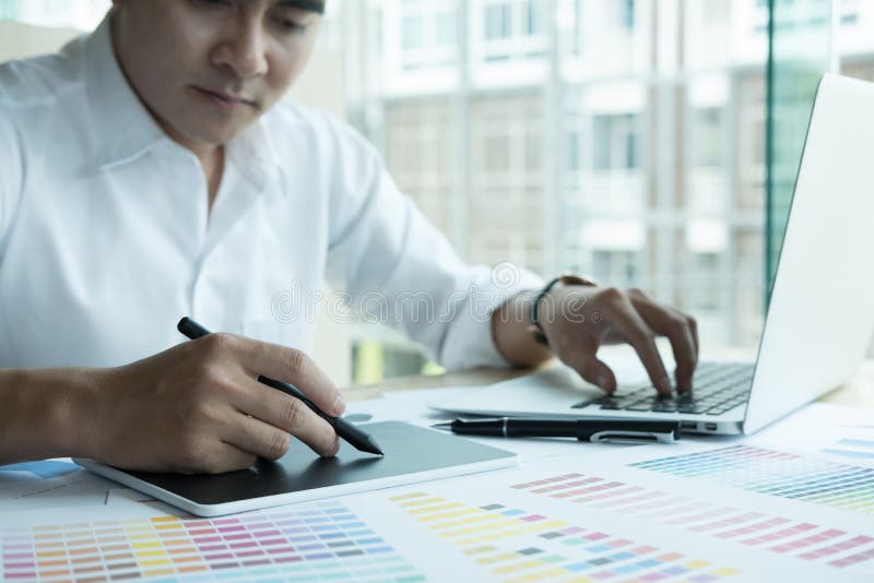 Young Graphic Designer Working with Computer and Color Swatch. C Stock ...