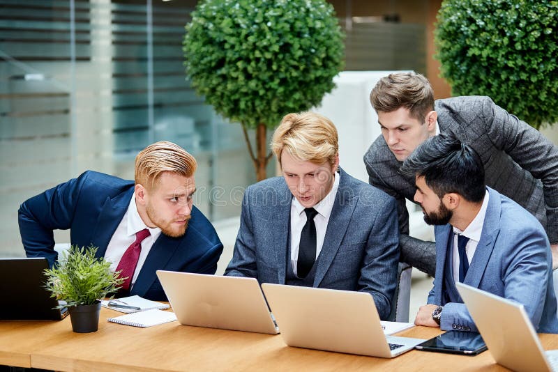 Young Group of Colleagues Discussing at Table Stock Image - Image of ...
