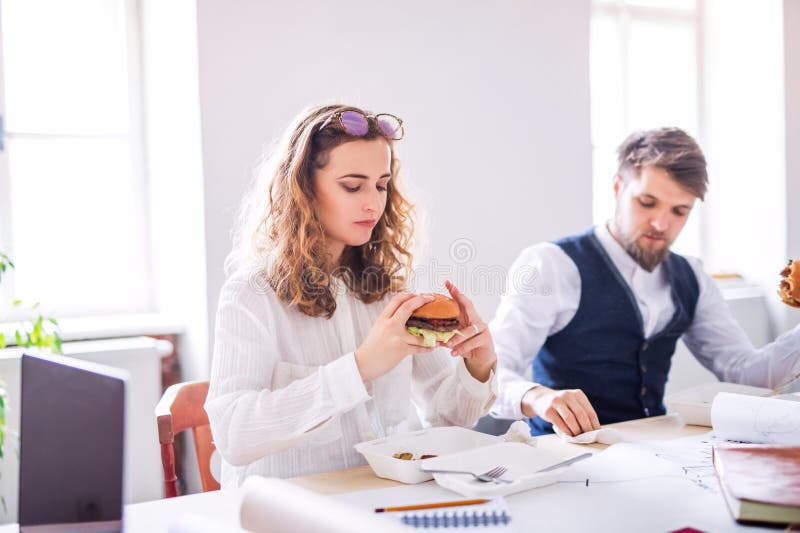 Young Group of Colleagues Having Quick Lunch Togeter in Startup Company ...