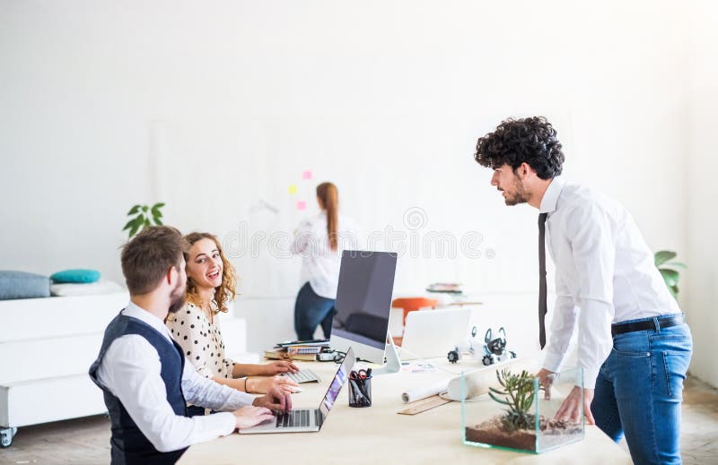 Young Group of Colleagues Working on a New Project Together in a ...