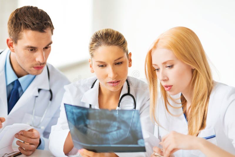 Young Group of Doctors Looking at X-ray Stock Image - Image of medical ...