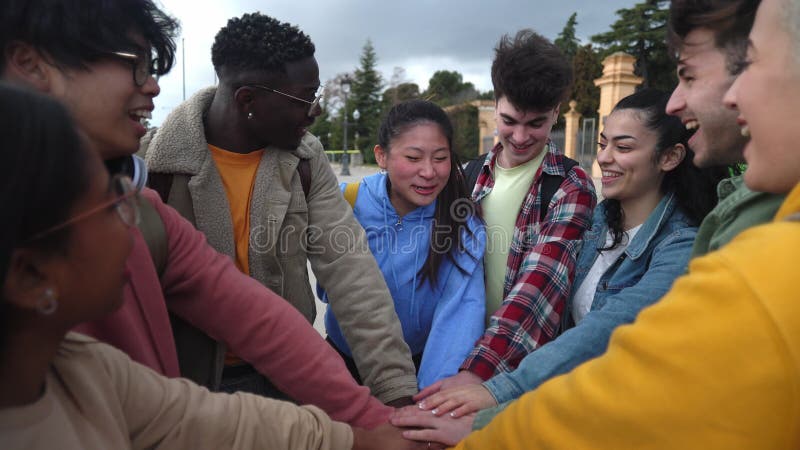 Young Group of Friends Stacking Hands Together and Celebrating Outdoors ...