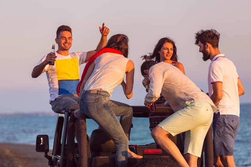 Young Group Having Fun on the Beach and Dancing in a Convertible Car ...