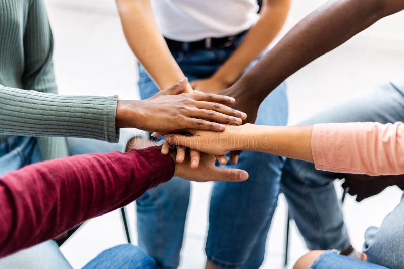 Young Group of People Sitting in Circle Stacking Hands Stock Image ...