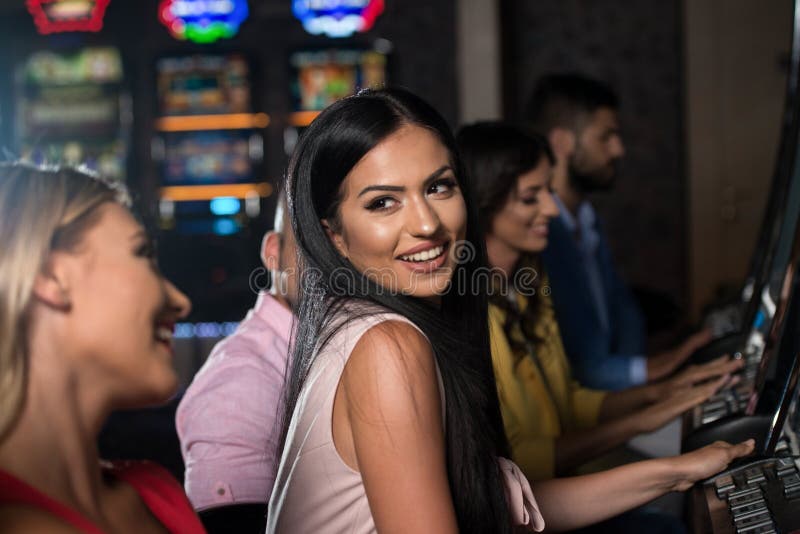 Happy Friends Playing Arcade Machine in a Casino Stock Image - Image of ...