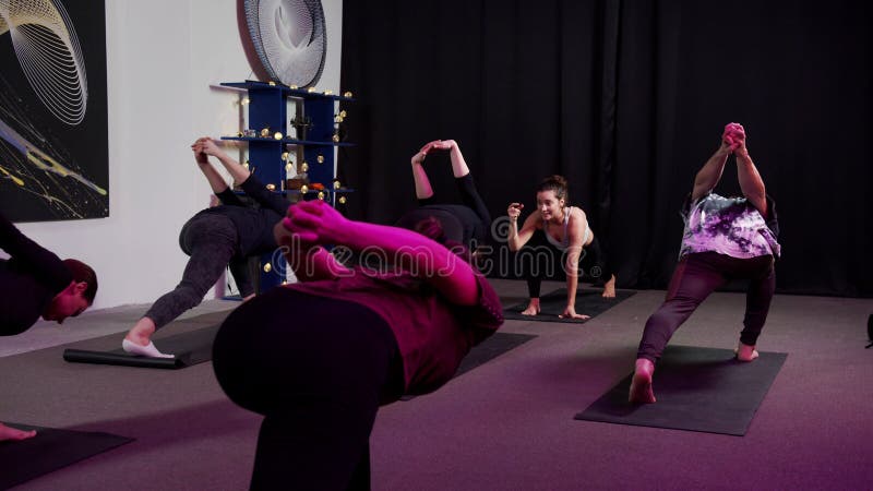 A Young Group Stretching with the Help of a Hands Locked Behind the ...