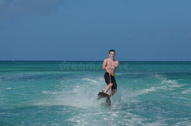 Young Guy in Aruba Riding on a Wakeboard Stock Photo - Image of ...