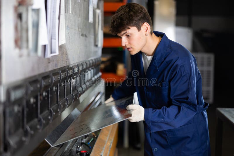 Young Guy Bends Sheet of Metal Under Pressure Stock Photo - Image of ...