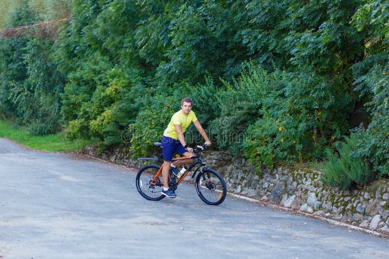A Young Guy on a Bike Outdoors Stock Photo - Image of shirt, nature ...