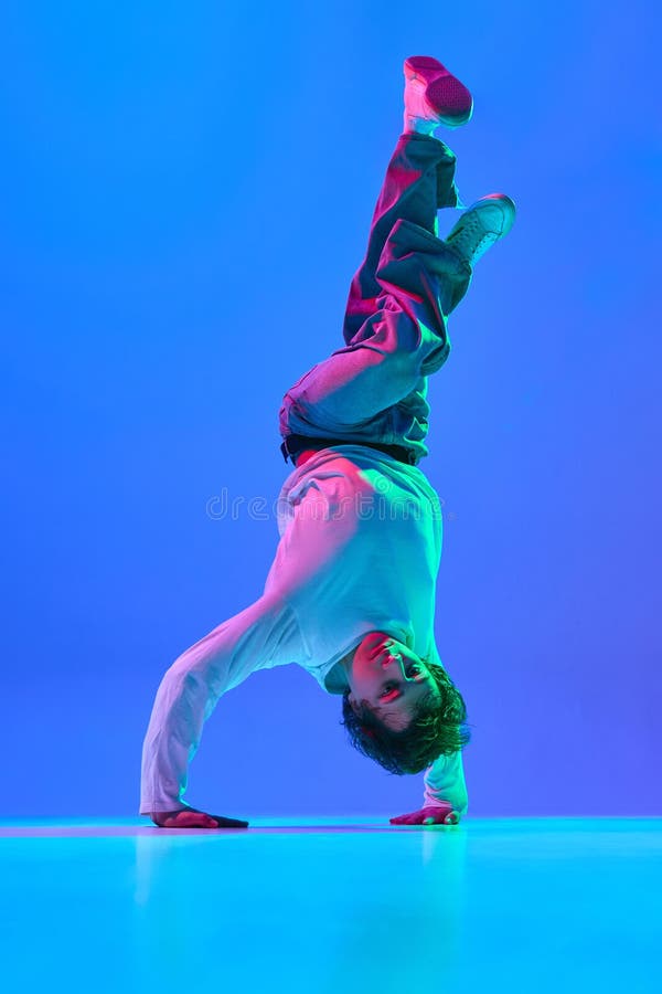 Young Breakdancer Balancing on One Hand Against White Background. Ffull ...