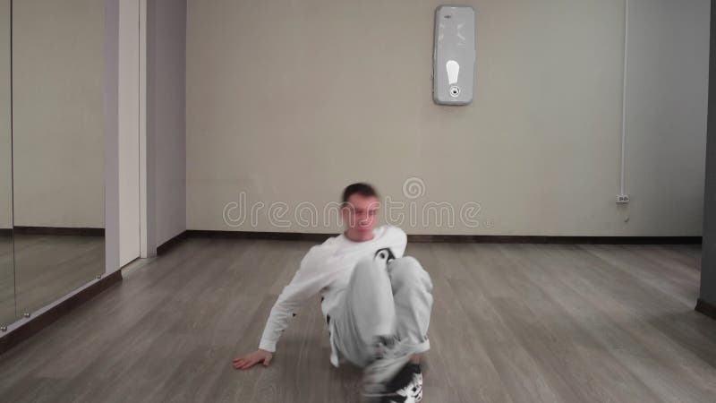 Young Guy Breakdancer Dances Hip Hop on Floor in Studio. Handsome Guy ...