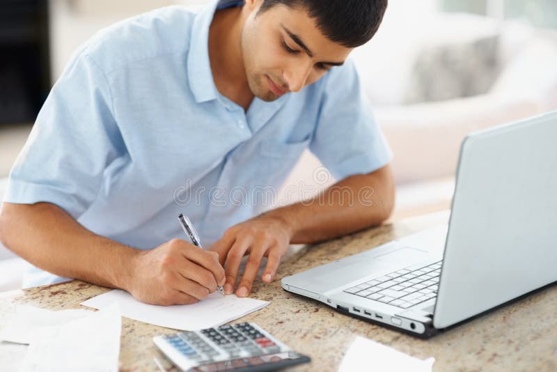 Young Guy Calculating Using Calculator and Laptop Stock Image - Image ...