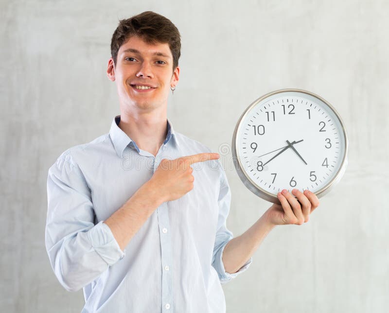 Young Guy Posing with Clock in Studio Stock Image - Image of deadline ...