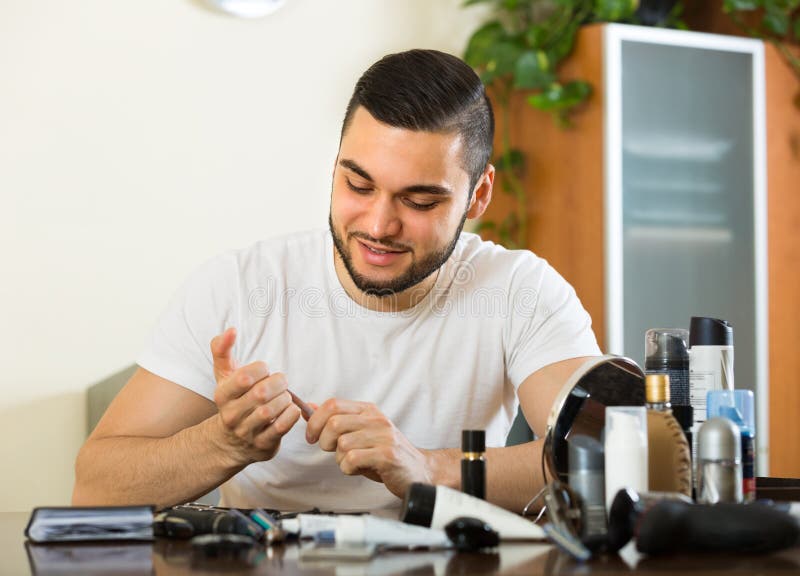 Young guy cutting nails stock image. Image of mirror - 74153393