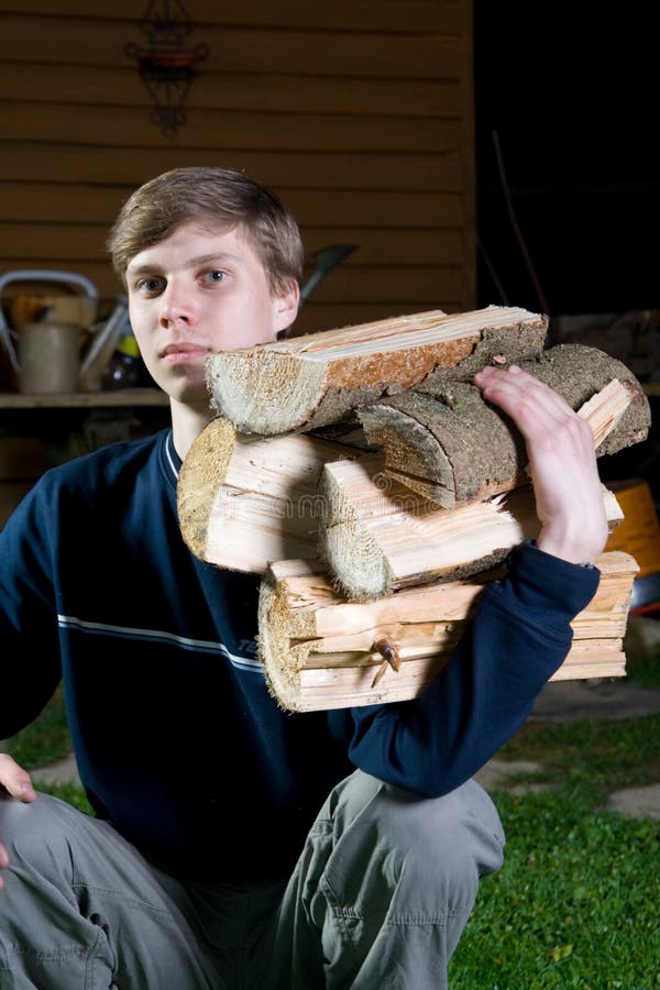 The Young Guy With Fire Wood Stock Image - Image of grass, field: 5315769