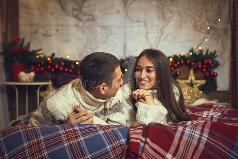 Young Guy and His Girlfriend are Lying on the Bed and Discussing Plans ...