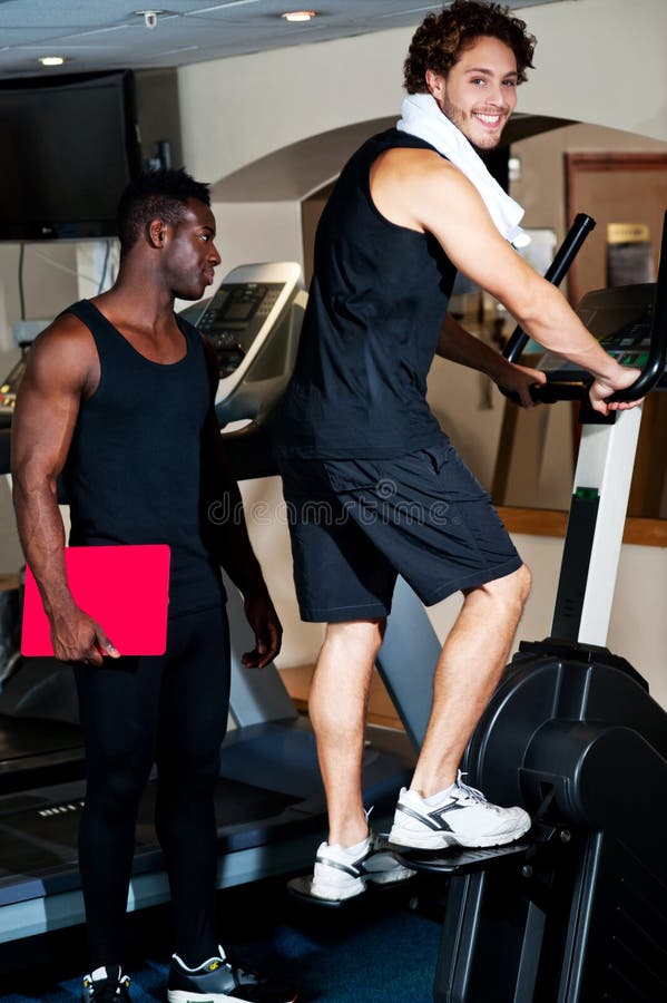 Young Guy with His Personal Trainer beside Him Stock Photo - Image of ...