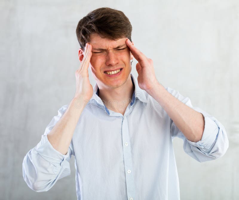 Young Guy Holding on To His Sore Head Stock Image - Image of showing ...