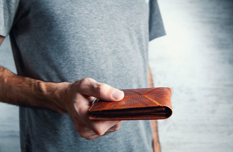 Young guy holding a wallet stock image. Image of money - 208325615