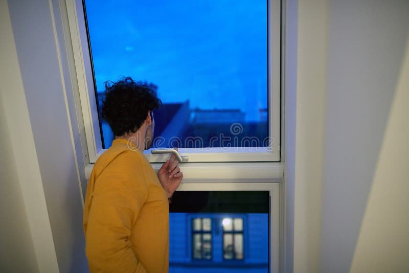 A Young Guy Looking through the Window in the Home. Morning, Home ...