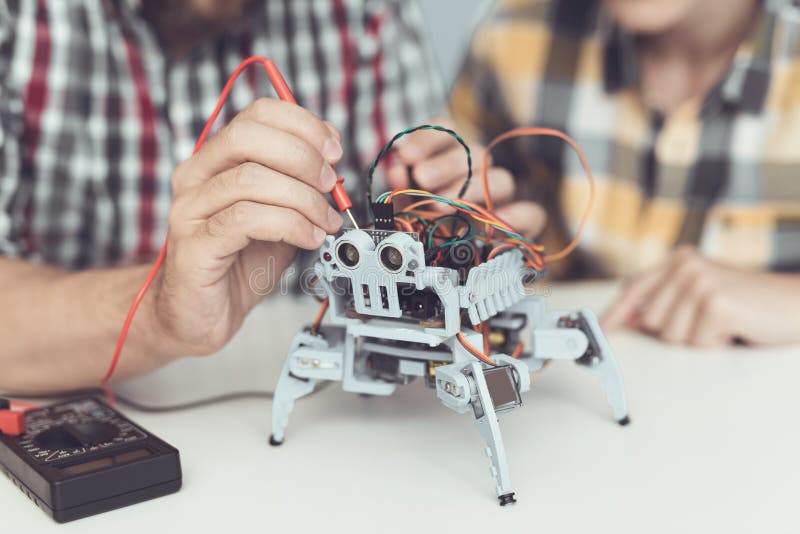 A Young Guy Looks with Delight As a Man Conducts Control Measurements ...