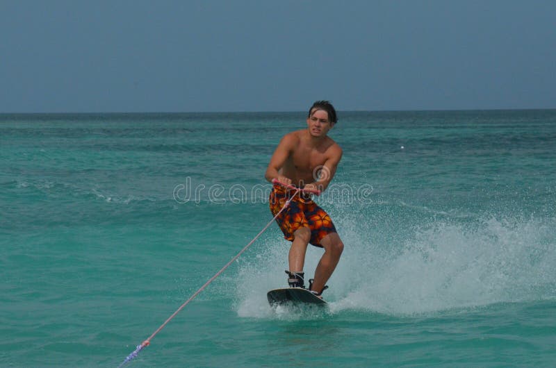 Young Guy Making a Funny Face while Wakeboarding Stock Image - Image of ...