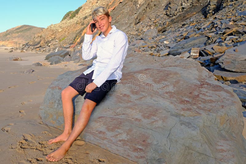Young Guy Making a Phone Call at the Beach Stock Image - Image of male ...