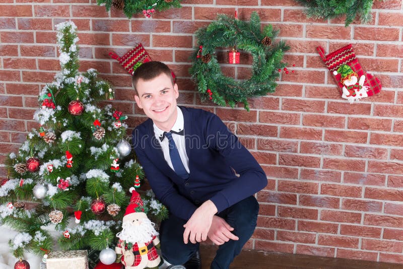 Young Guy Next To a Christmas Tree Stock Image - Image of male, young ...